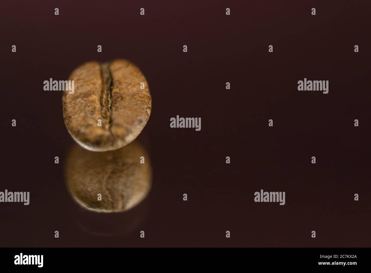 Gold coffee bean. Red background Stock Photo - Alamy