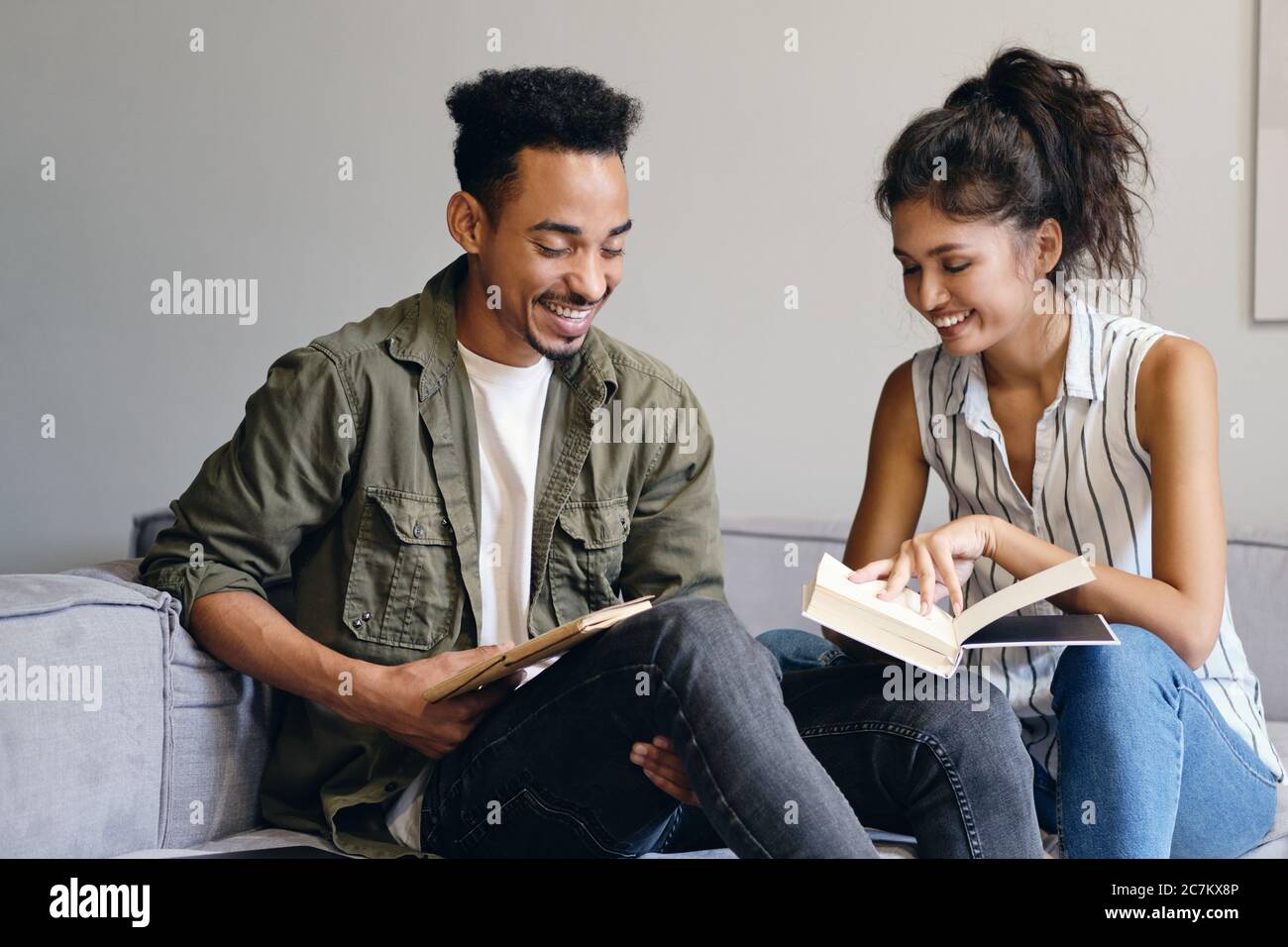 Young smiling African American man and pretty Asian woman joyfully ...