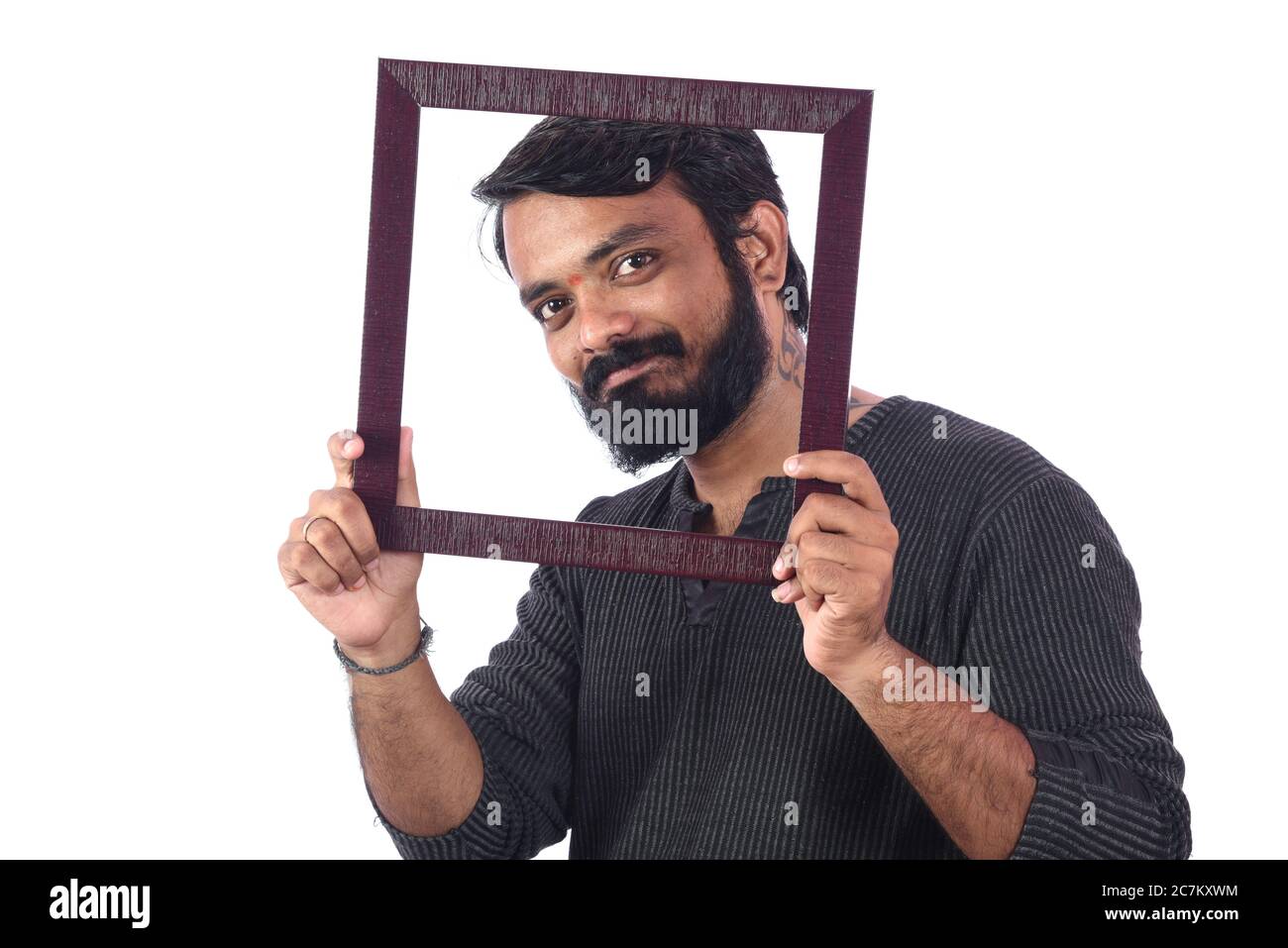 Man posing with picture frame on a white background, portrait Stock ...