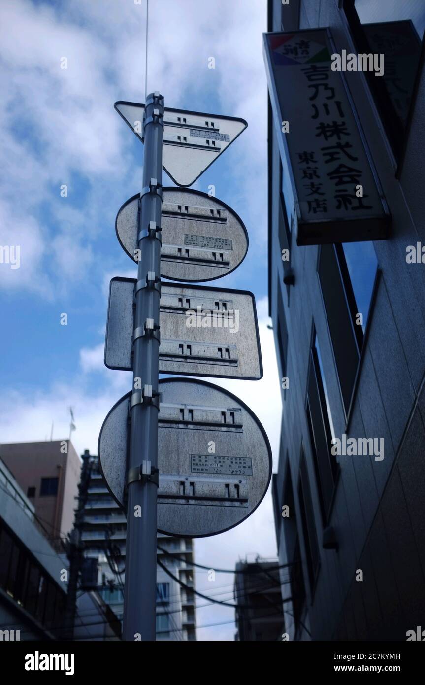 Low angle shot of street signs of different shapes attached to a metal ...