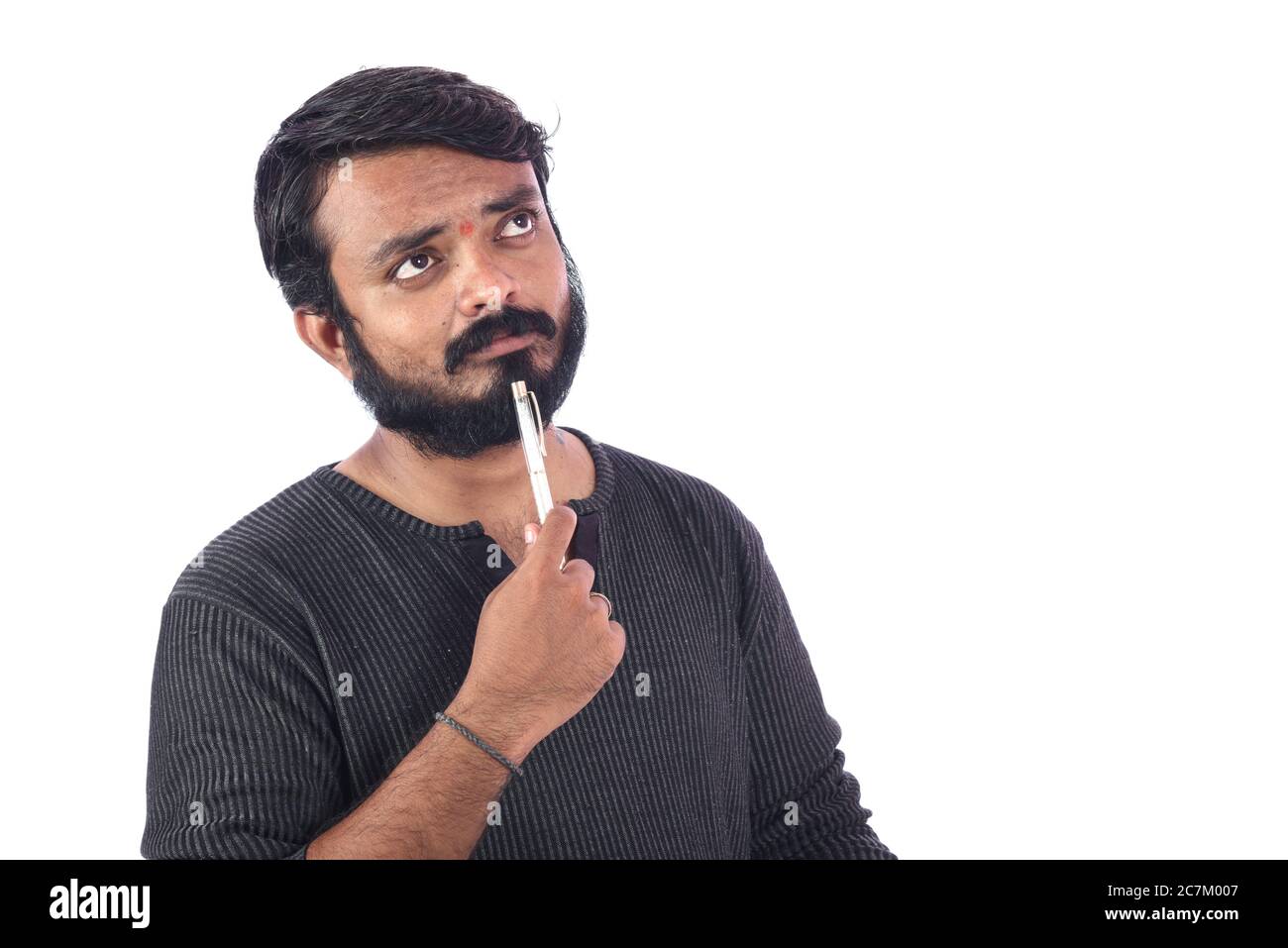 Young man thinking about something for writing in diary isolated on ...