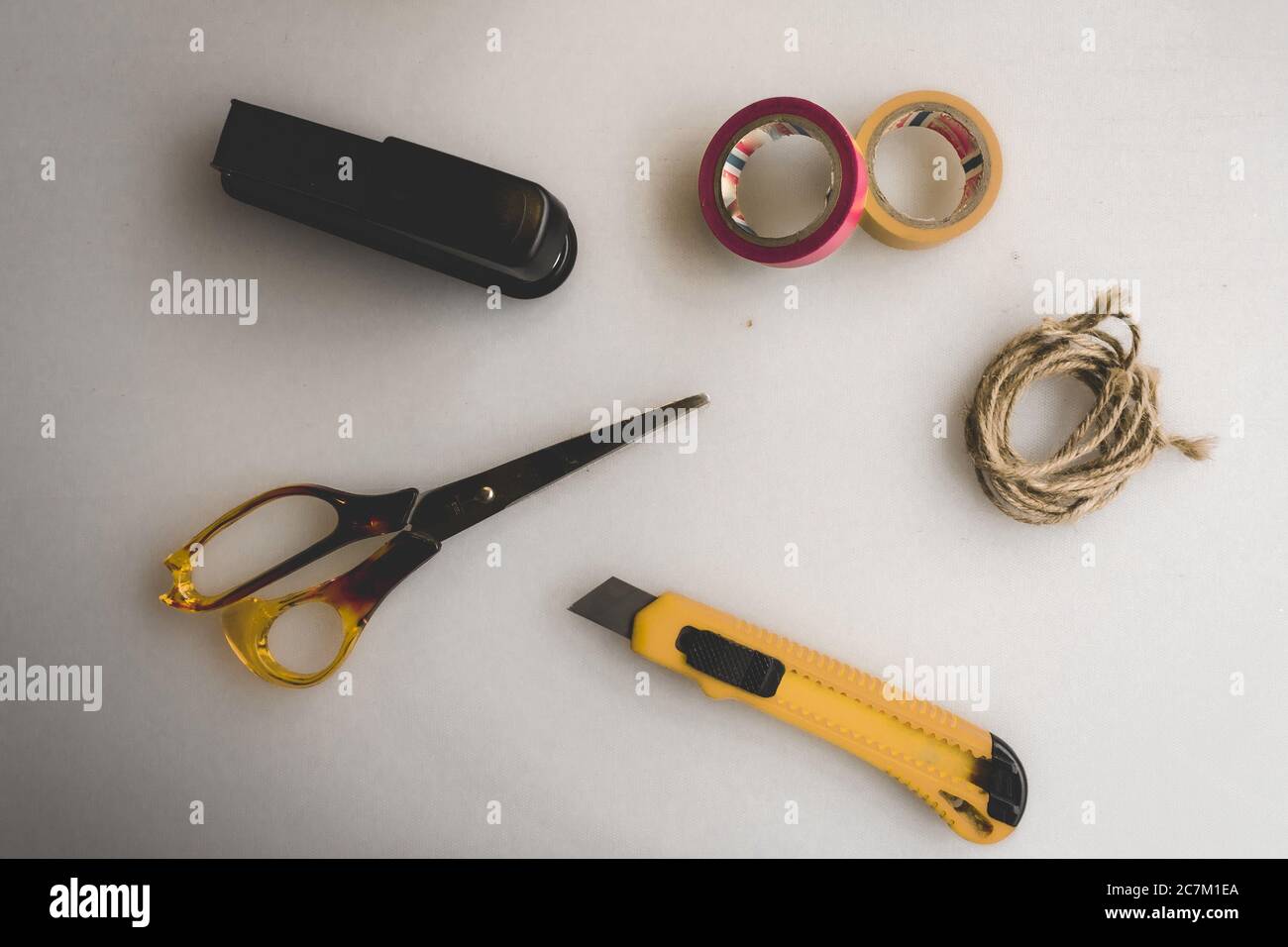 High angle shot of different tailor tools - scissors, thread, knife and ...