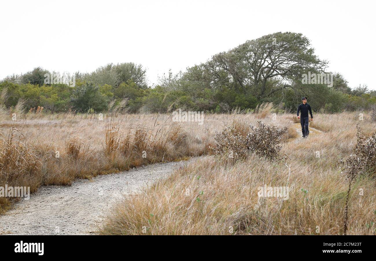 Grand Isle, Louisiana - February 2018: A hiker walks along Fiddlers ...