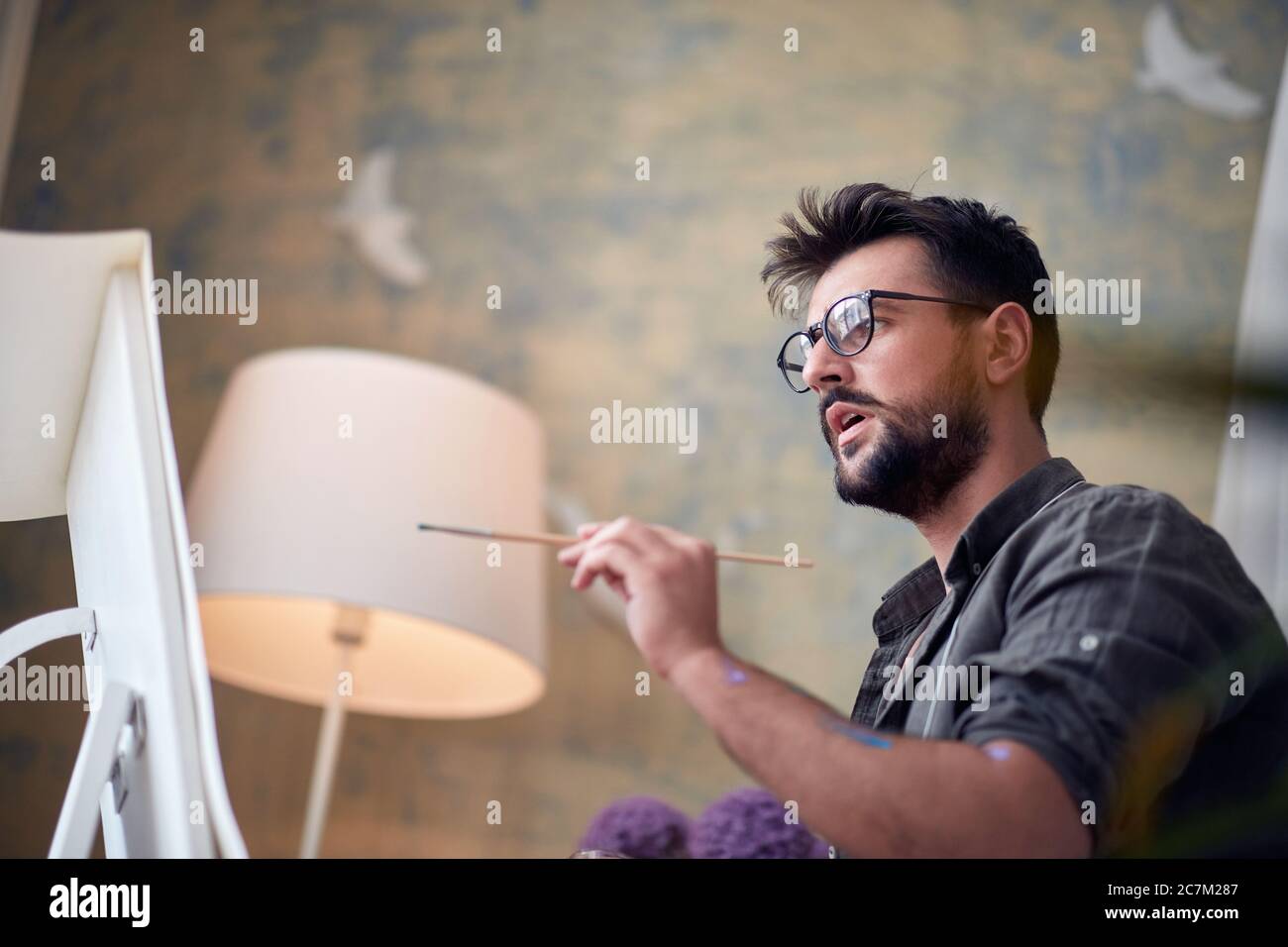 Young handsome painter caught in action in relaxed atmosphere Stock ...