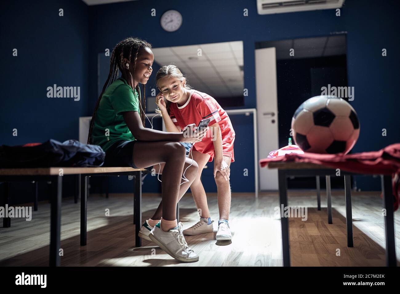 smiling girl soccer player before training listen music on phone in ...