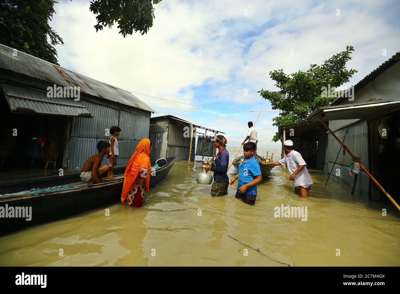 Wading through flood water bangladesh hi-res stock photography and ...
