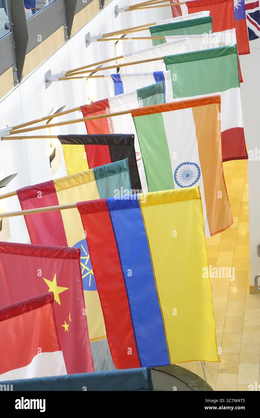 Vertical closeup shot of the flags of different countries on display in ...