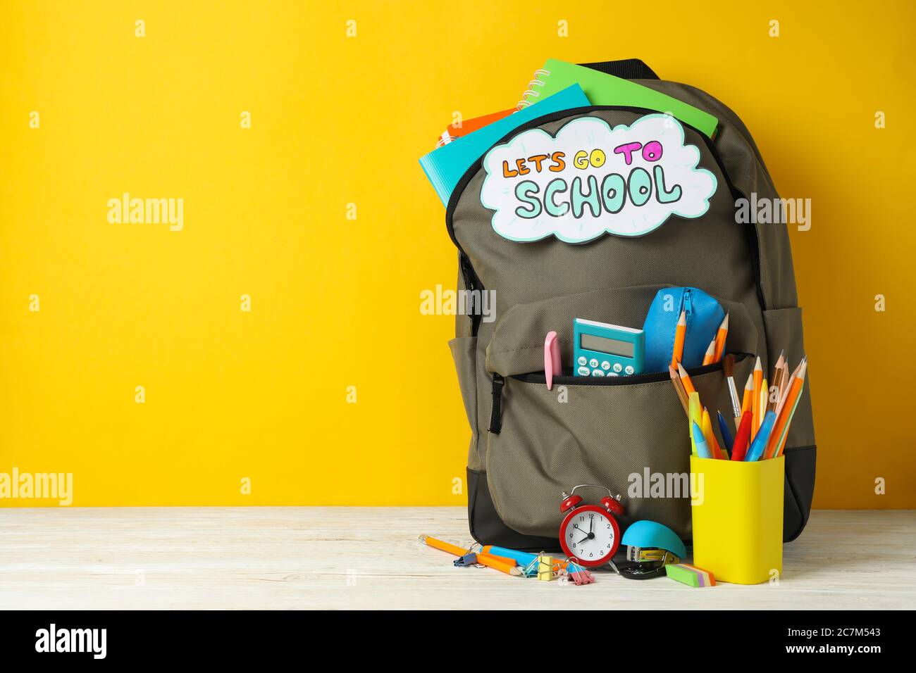 Text Let's go to school and school supplies on yellow background Stock ...