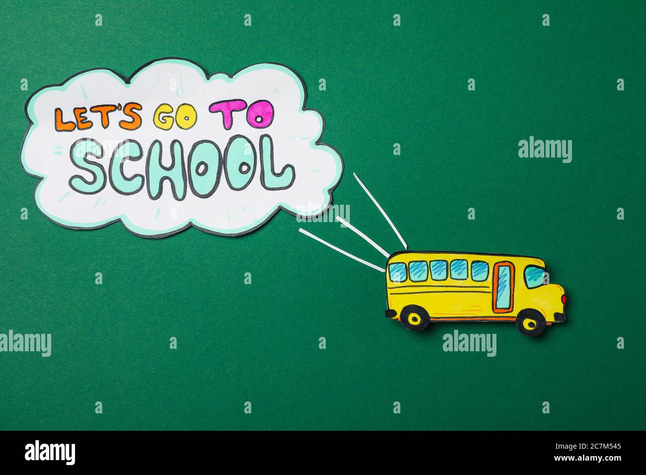 Decorative school bus and text Let's go to school on green background ...
