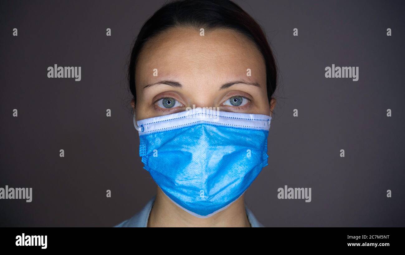 Close up portrait of a caucasian woman with sad blue eyes and a blue ...