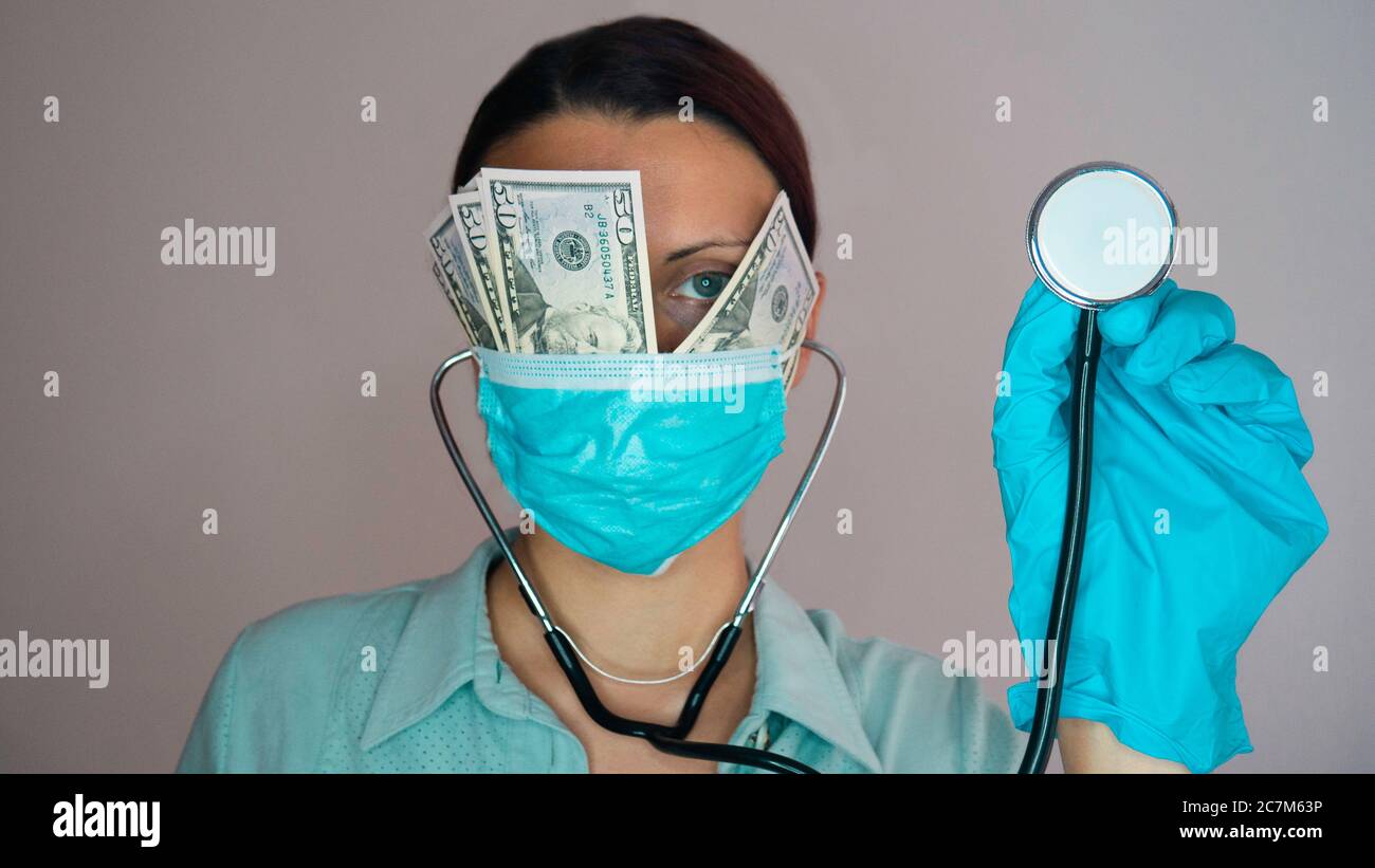 Bribery and corruption in medicine. Woman doctor looks through the ...