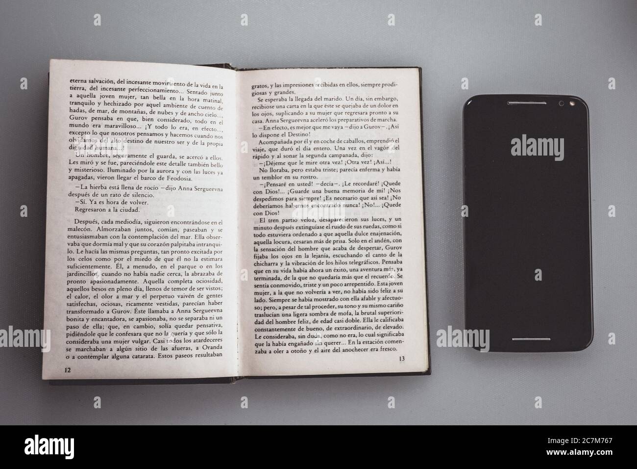 Overhead shot of an open book next to a phone Stock Photo - Alamy
