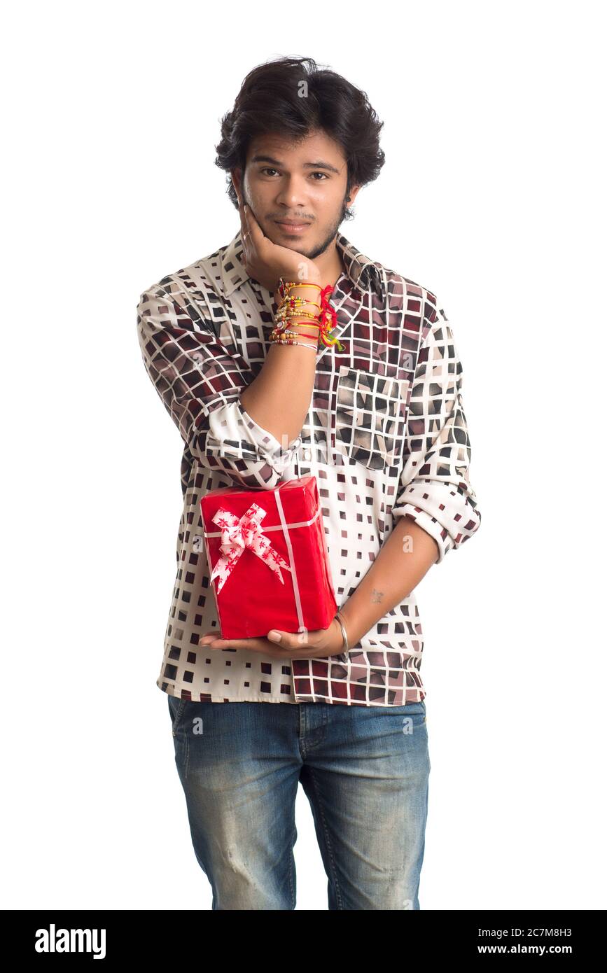Man or Brother showing rakhi on his hand with shopping bags and gift ...