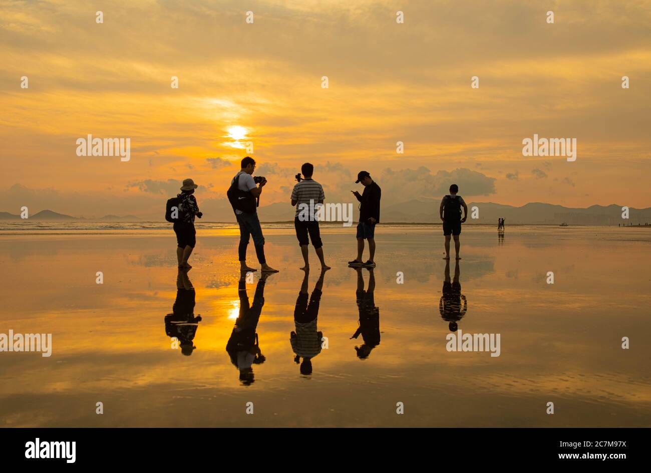 Beach sunset reflection Stock Photo - Alamy