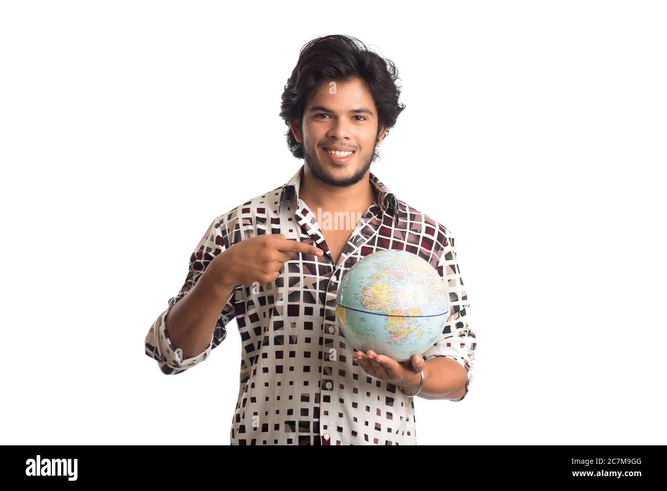 young man with a world globe on a white background Stock Photo - Alamy