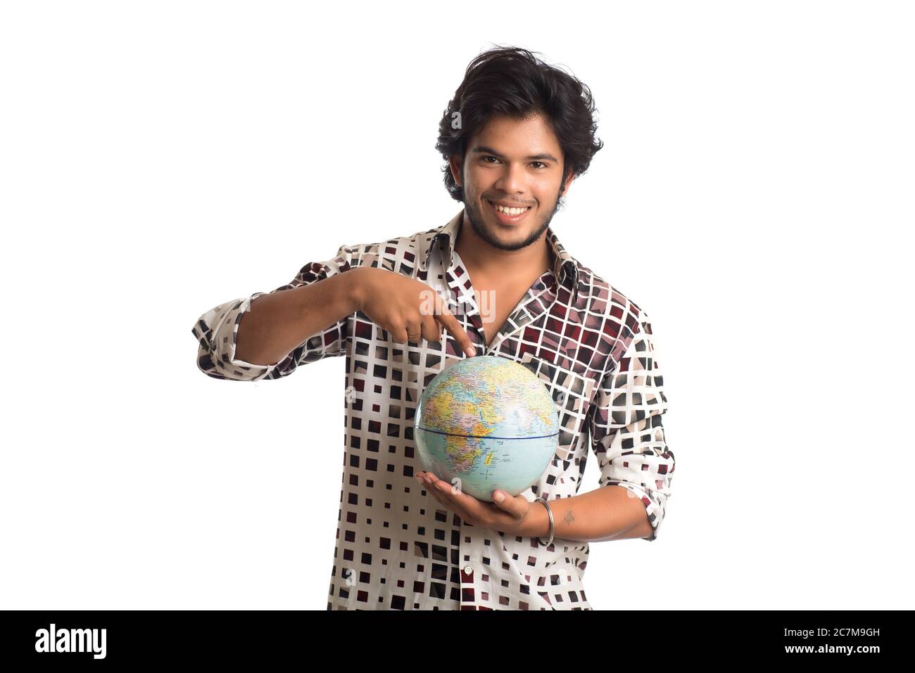young man with a world globe on a white background Stock Photo - Alamy