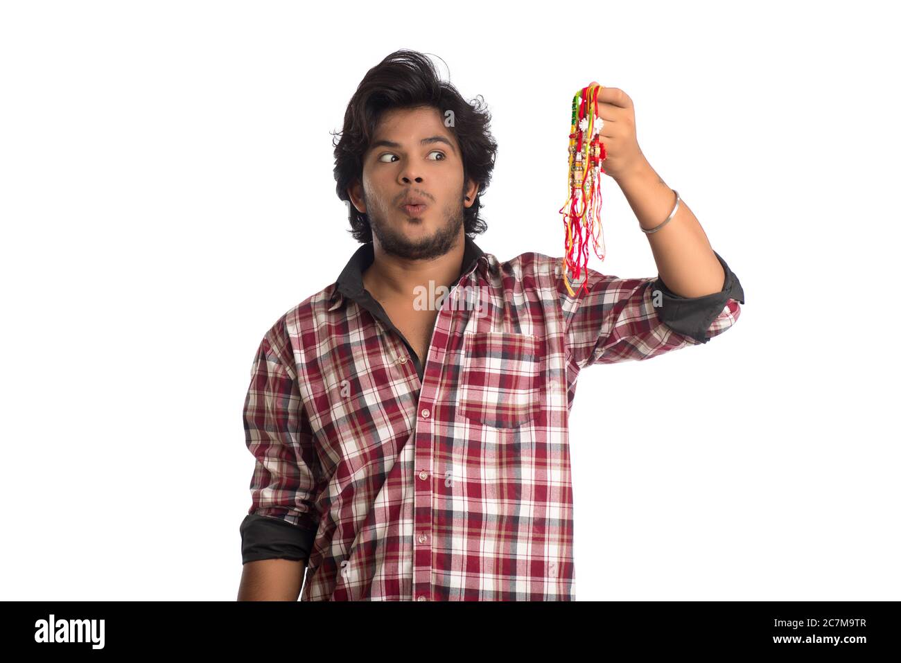 Young men showing rakhi in hand and giving expression on an occasion of ...