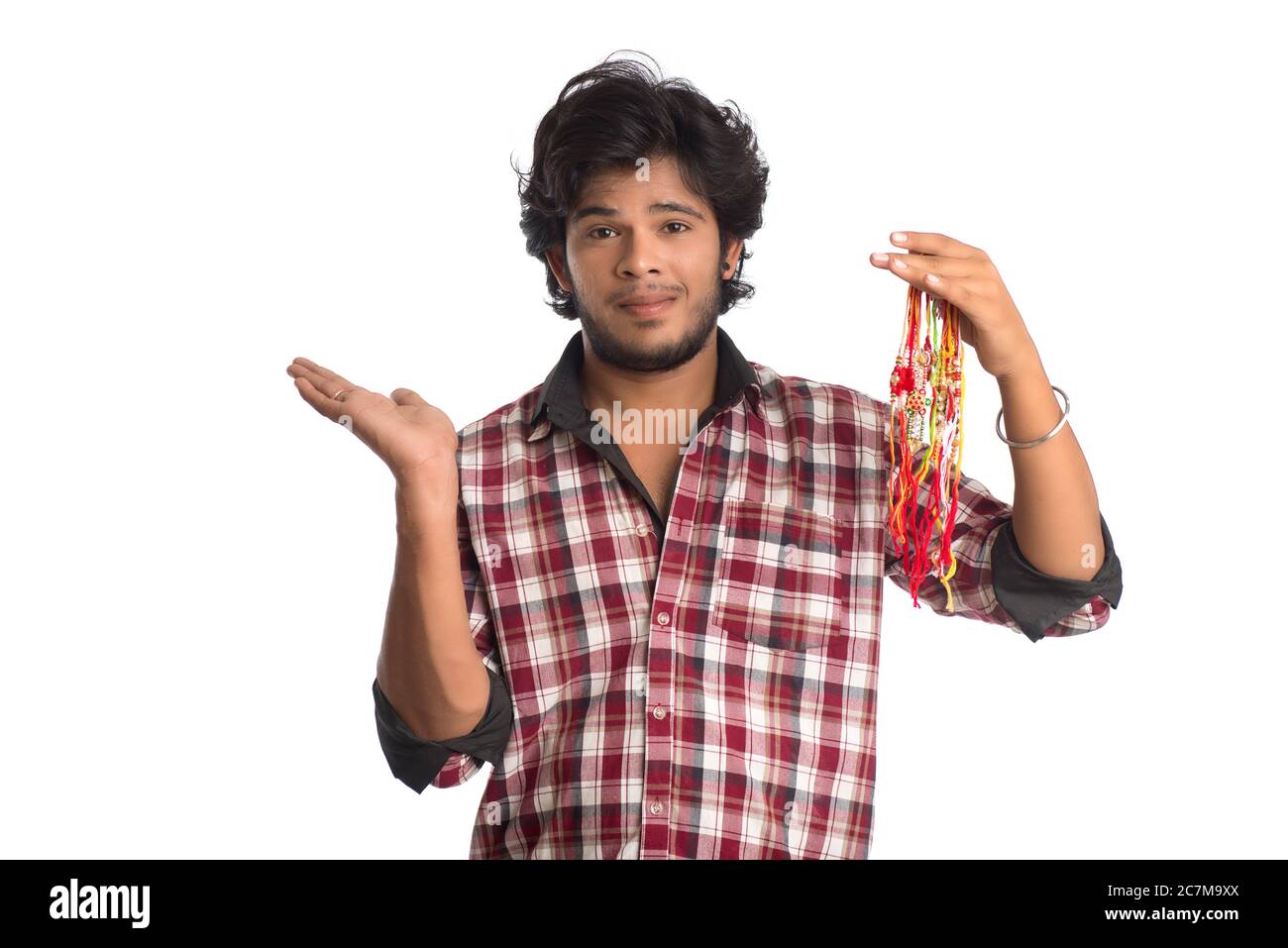 Young men showing rakhi in hand and giving expression on an occasion of ...
