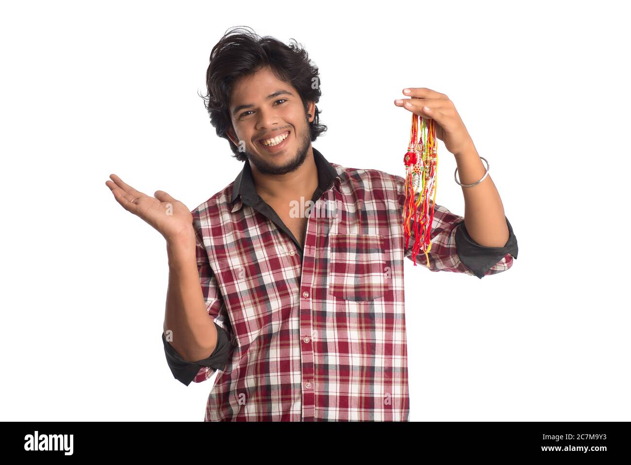 Young men showing rakhi in hand and giving expression on an occasion of ...