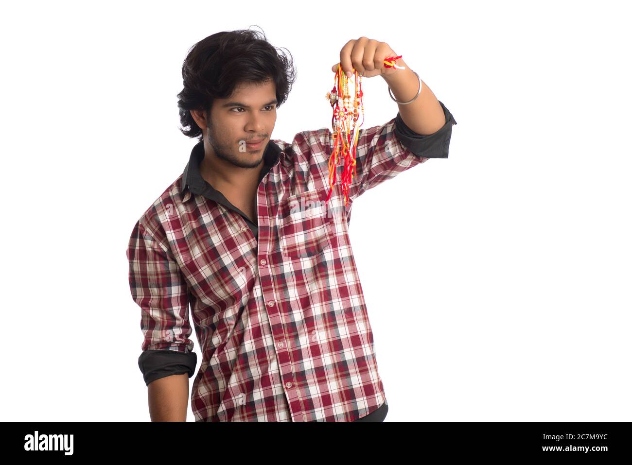 Young men showing rakhi in hand and giving expression on an occasion of ...