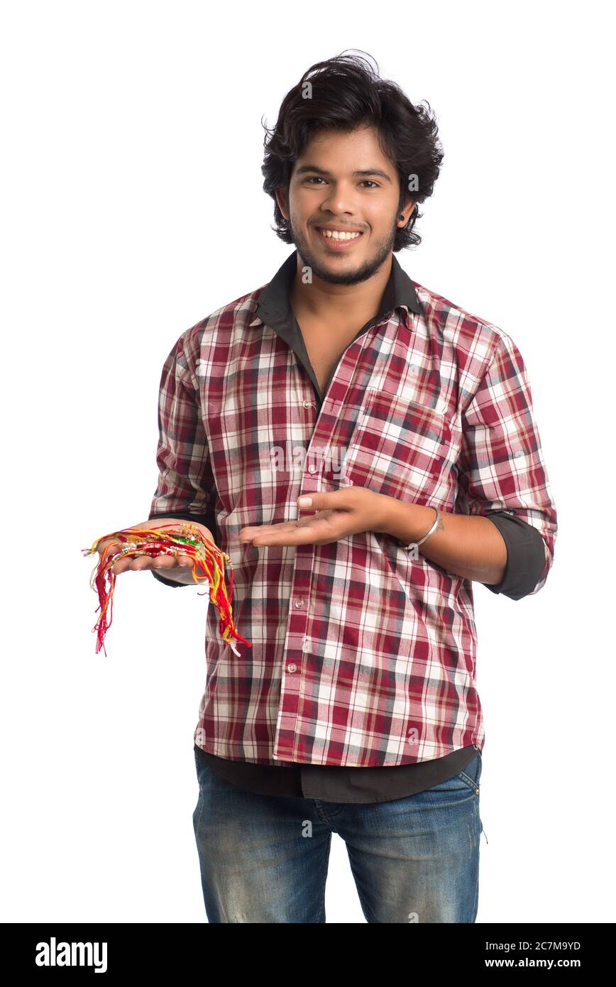 Young men showing rakhi in hand and giving expression on an occasion of ...