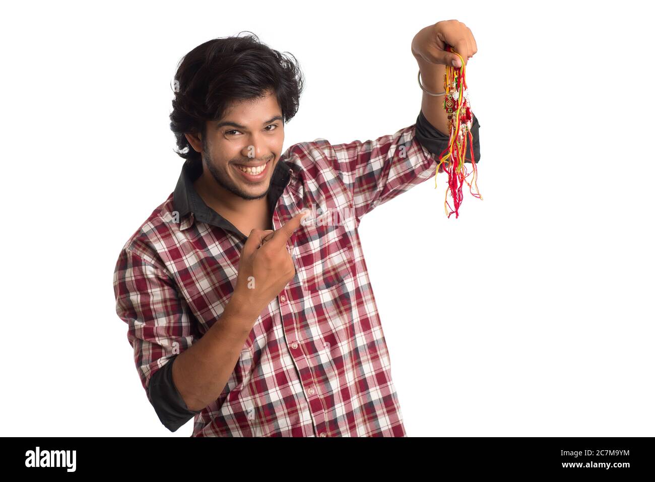 Young men showing rakhi in hand and giving expression on an occasion of ...