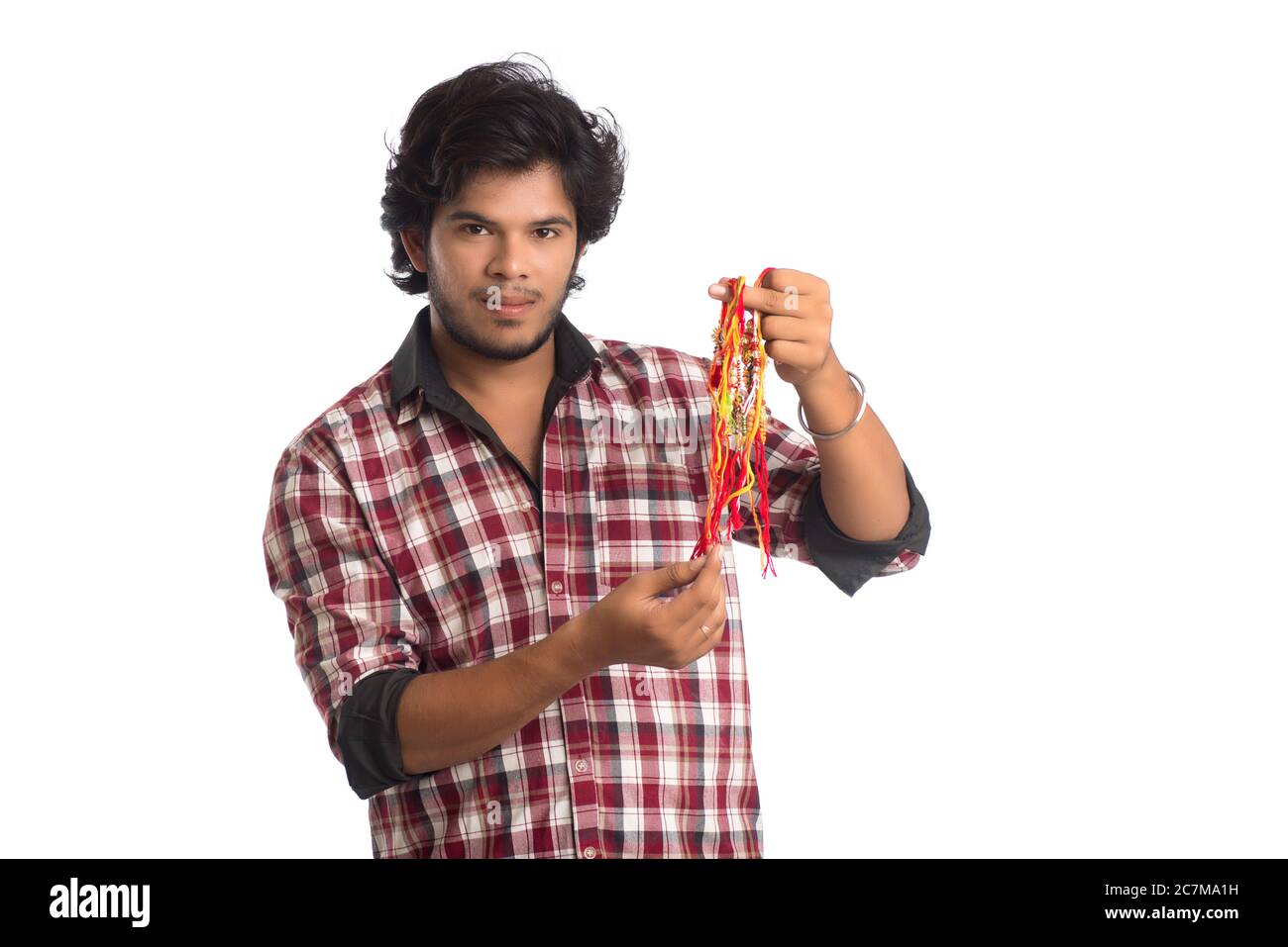 Young men showing rakhi in hand and giving expression on an occasion of ...