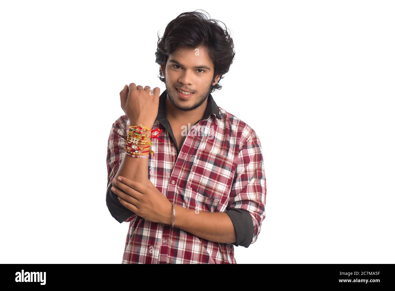 Young men showing rakhi on his hand on an occasion of Raksha Bandhan ...