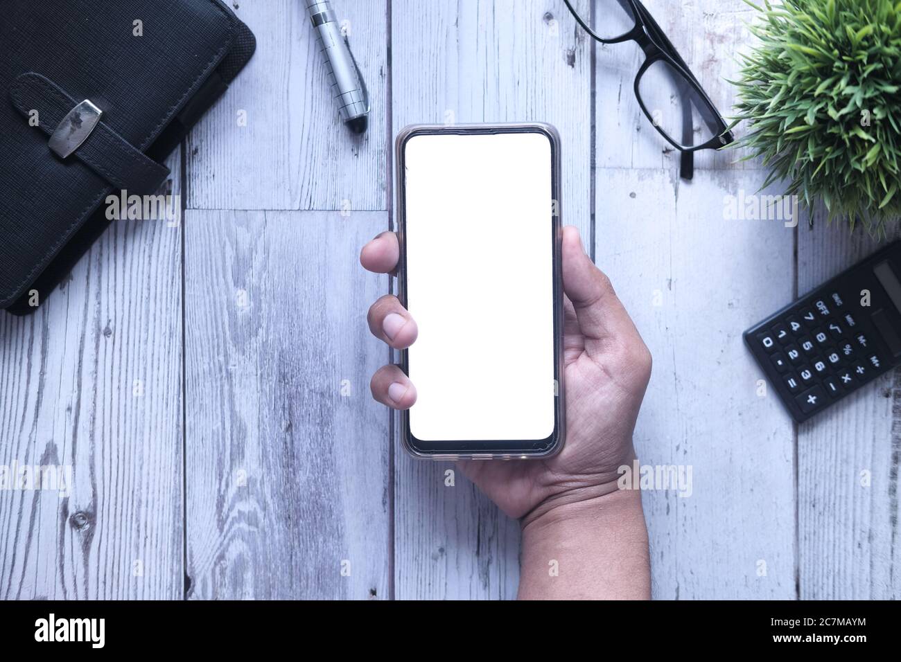 flat composition of hand holding smart phone on white background Stock ...