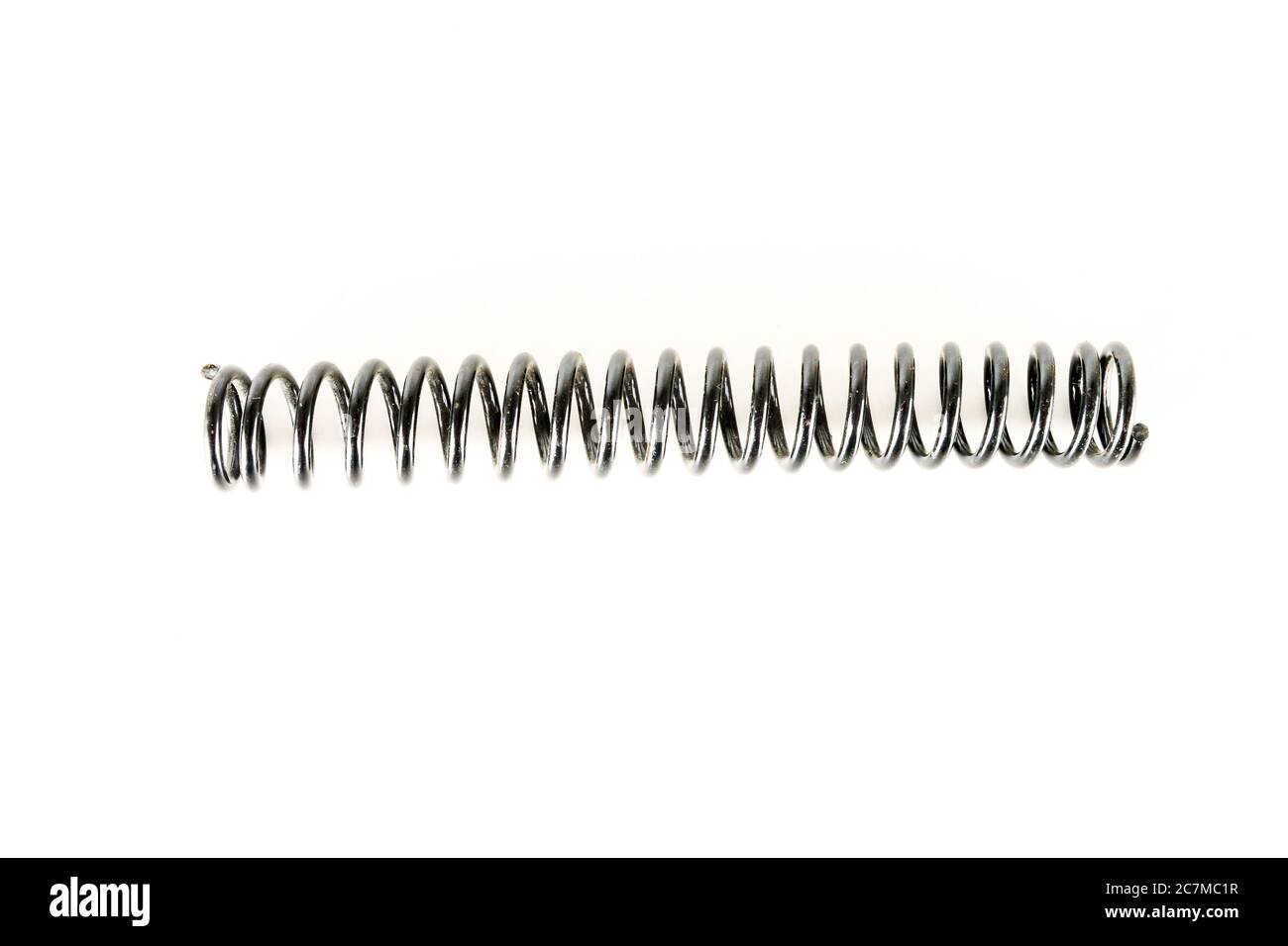 Gray metal spring on a white background Stock Photo - Alamy