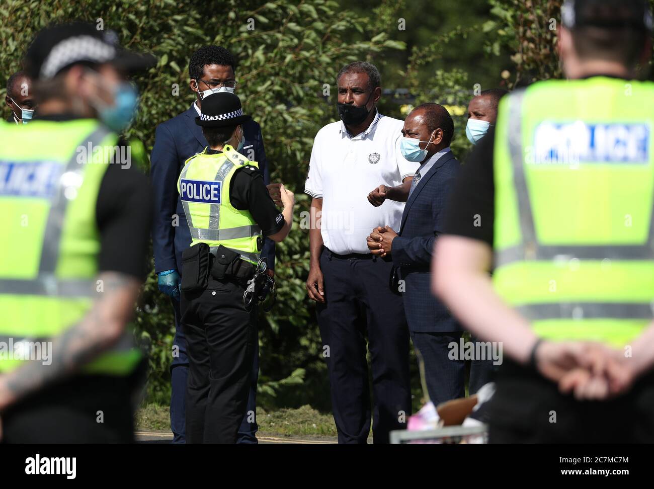 Police explain to mourners that there are too many people in the ...