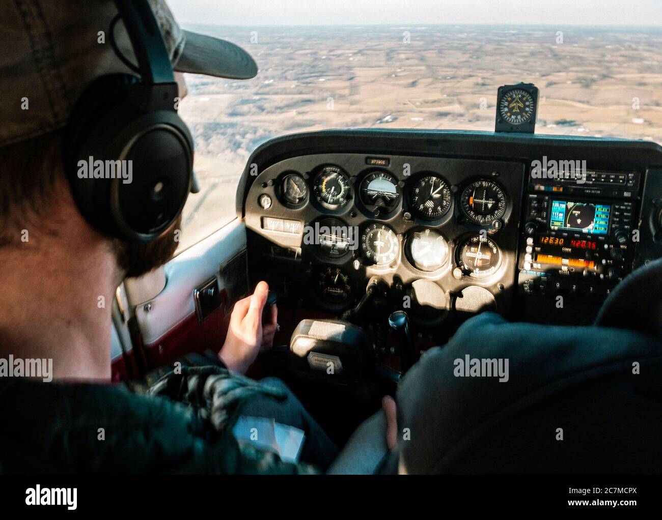 Pilot flying an aircraft at daytime Stock Photo - Alamy