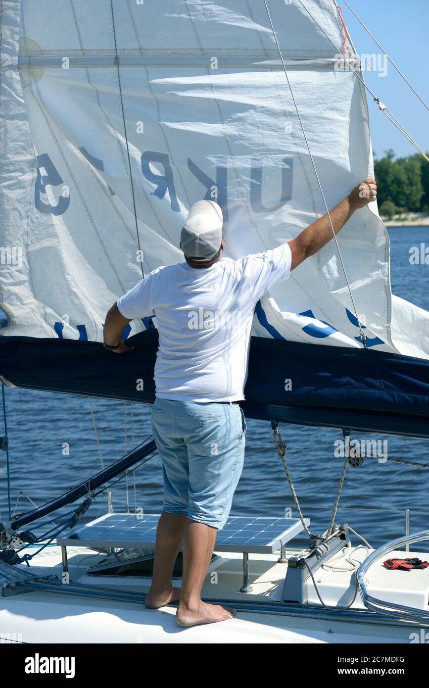 Yachtsman setting sail of yacht before race Stock Photo - Alamy