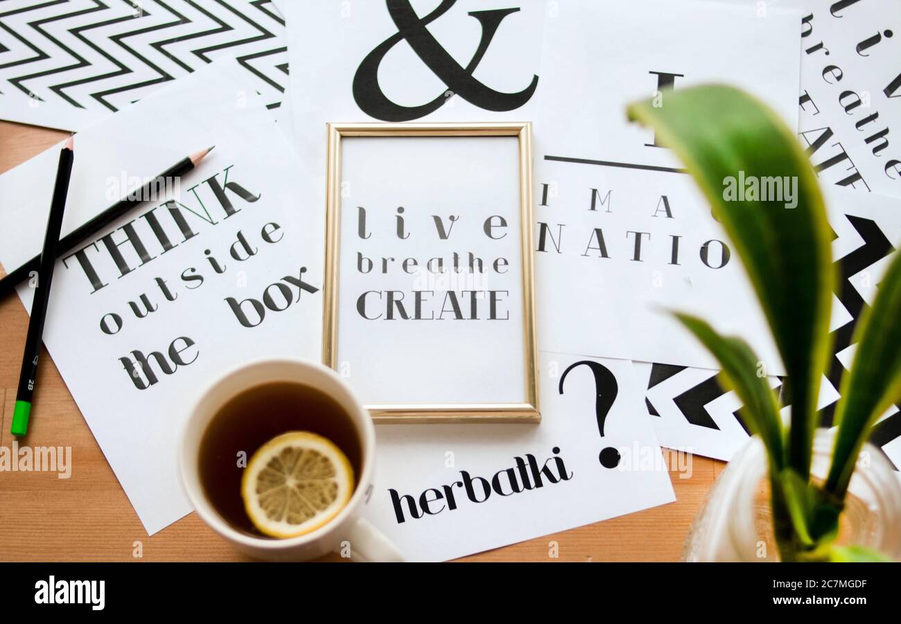 Overhead shot of several motivational quotes placed on the wooden table ...