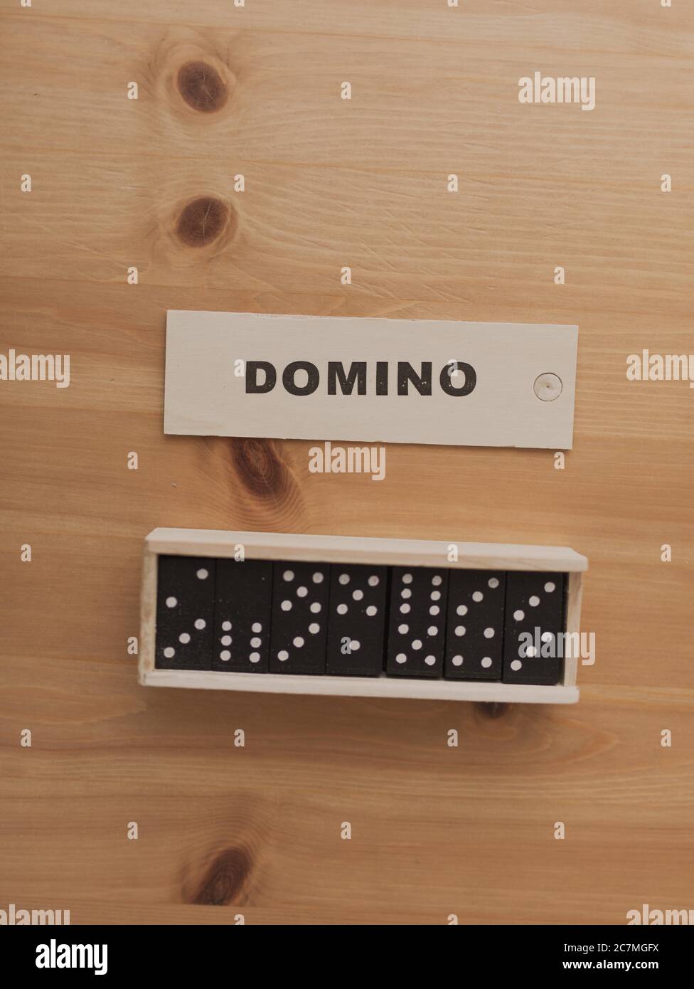 Overhead vertical shot of a domino sign and the dominoes collected and ...