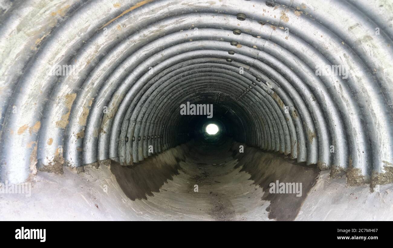 Drainage pipe under highway (culvert). Filming inside pipe Stock Photo ...