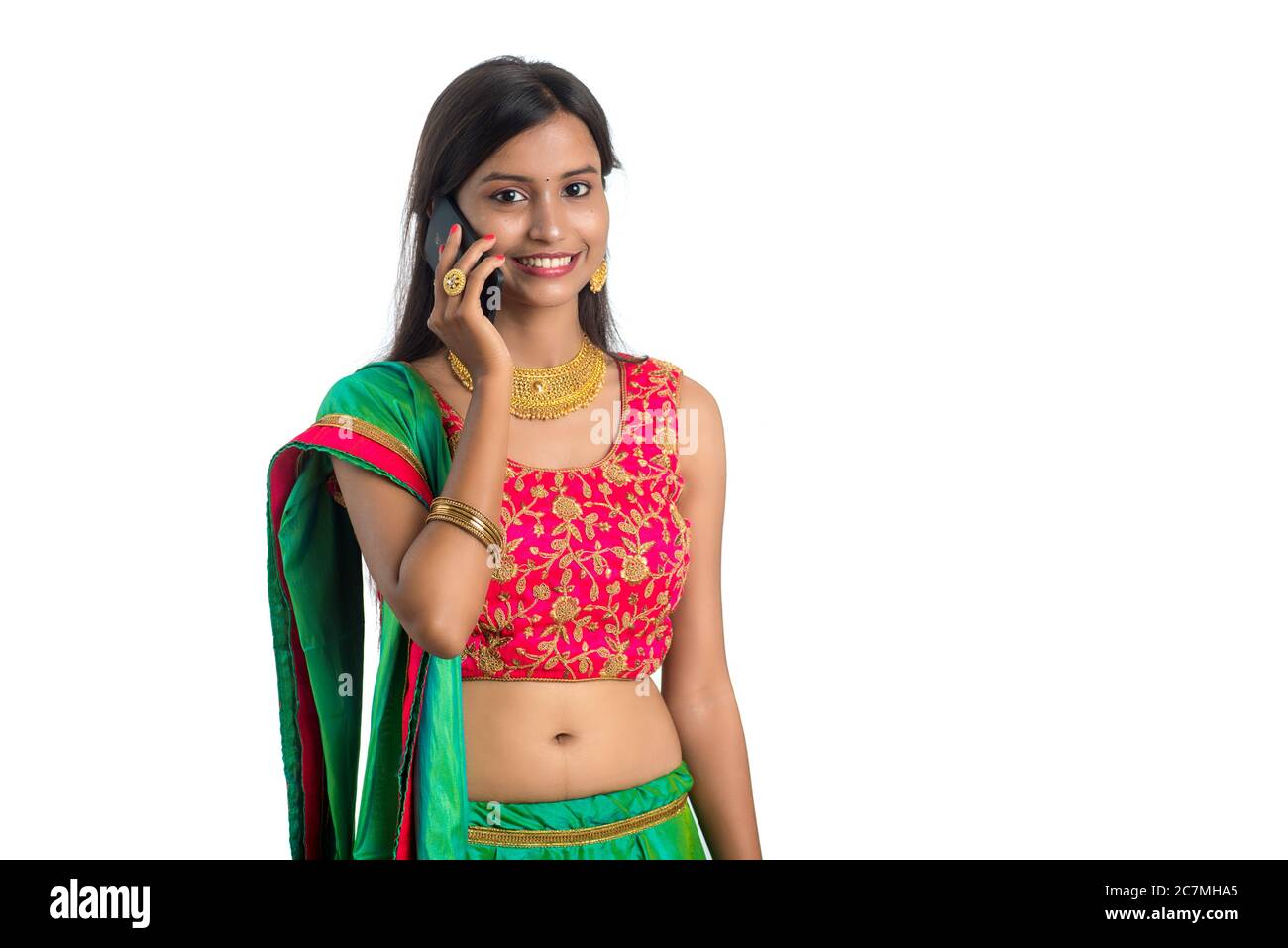 Young Indian traditional girl using a mobile phone or smartphone ...