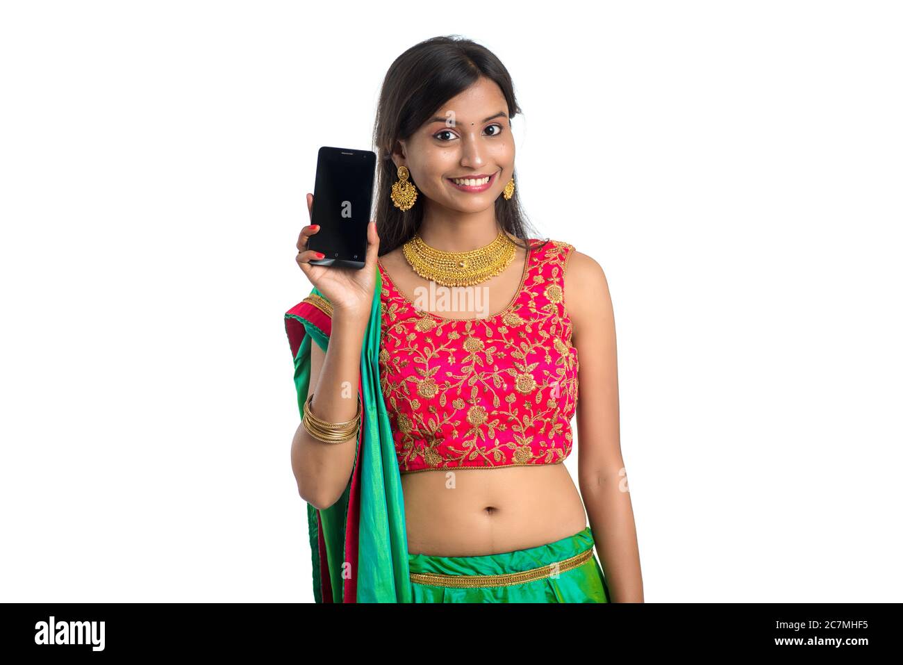 Young Indian traditional girl using a mobile phone or smartphone and ...