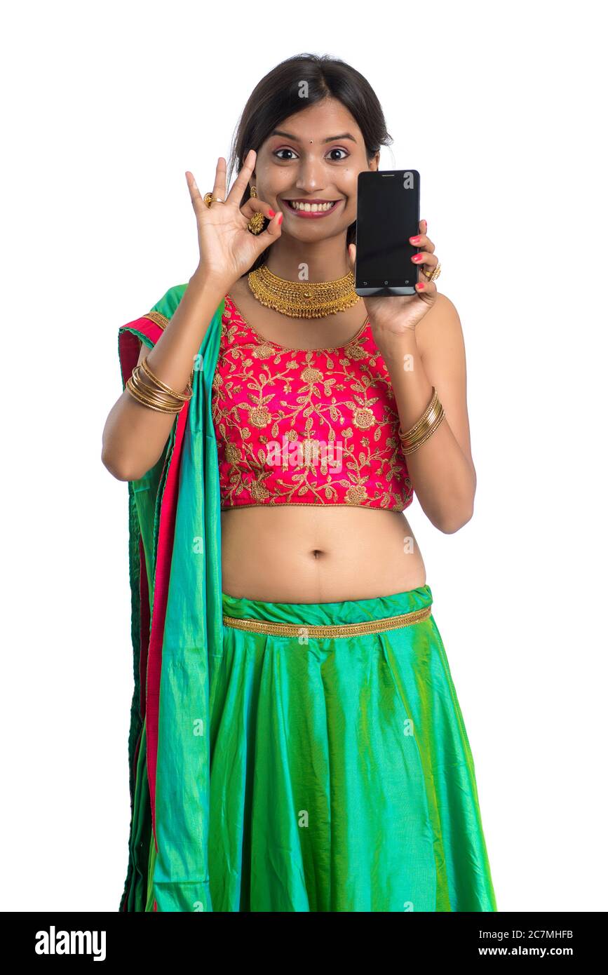 Young Indian traditional girl using a mobile phone or smartphone and ...