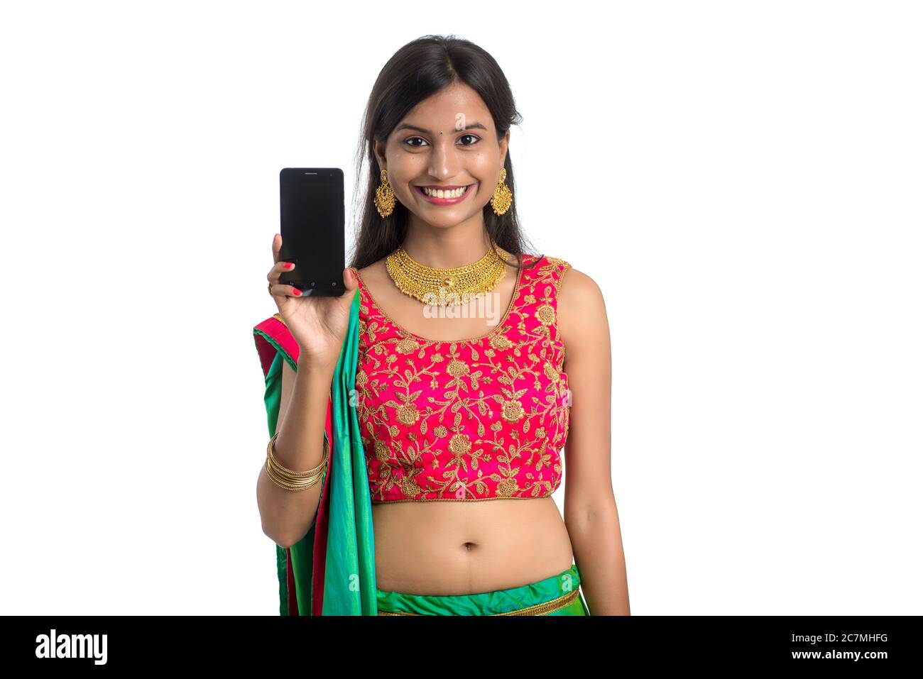Young Indian traditional girl using a mobile phone or smartphone and ...