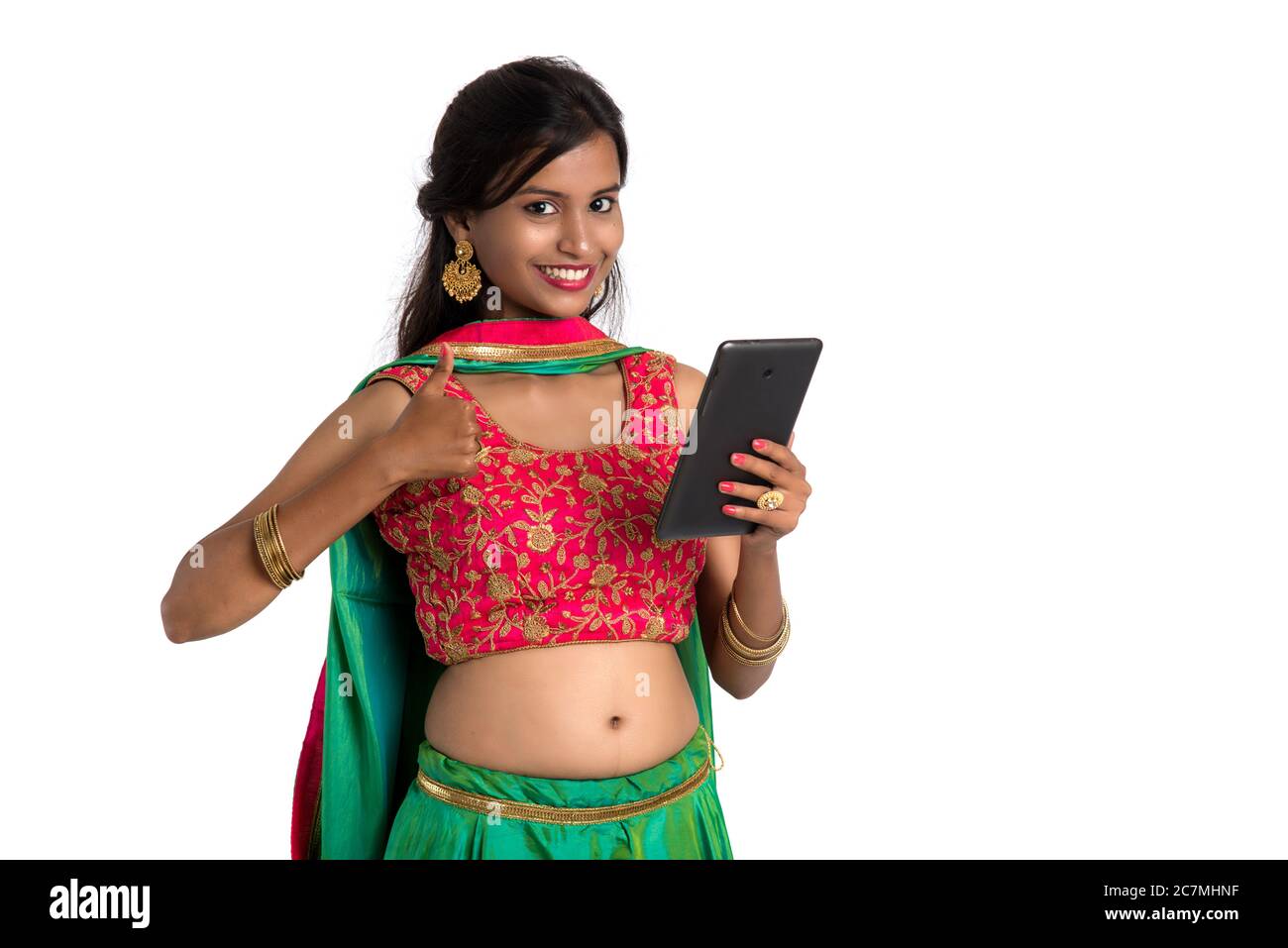Young Indian traditional girl using a mobile phone or smartphone ...