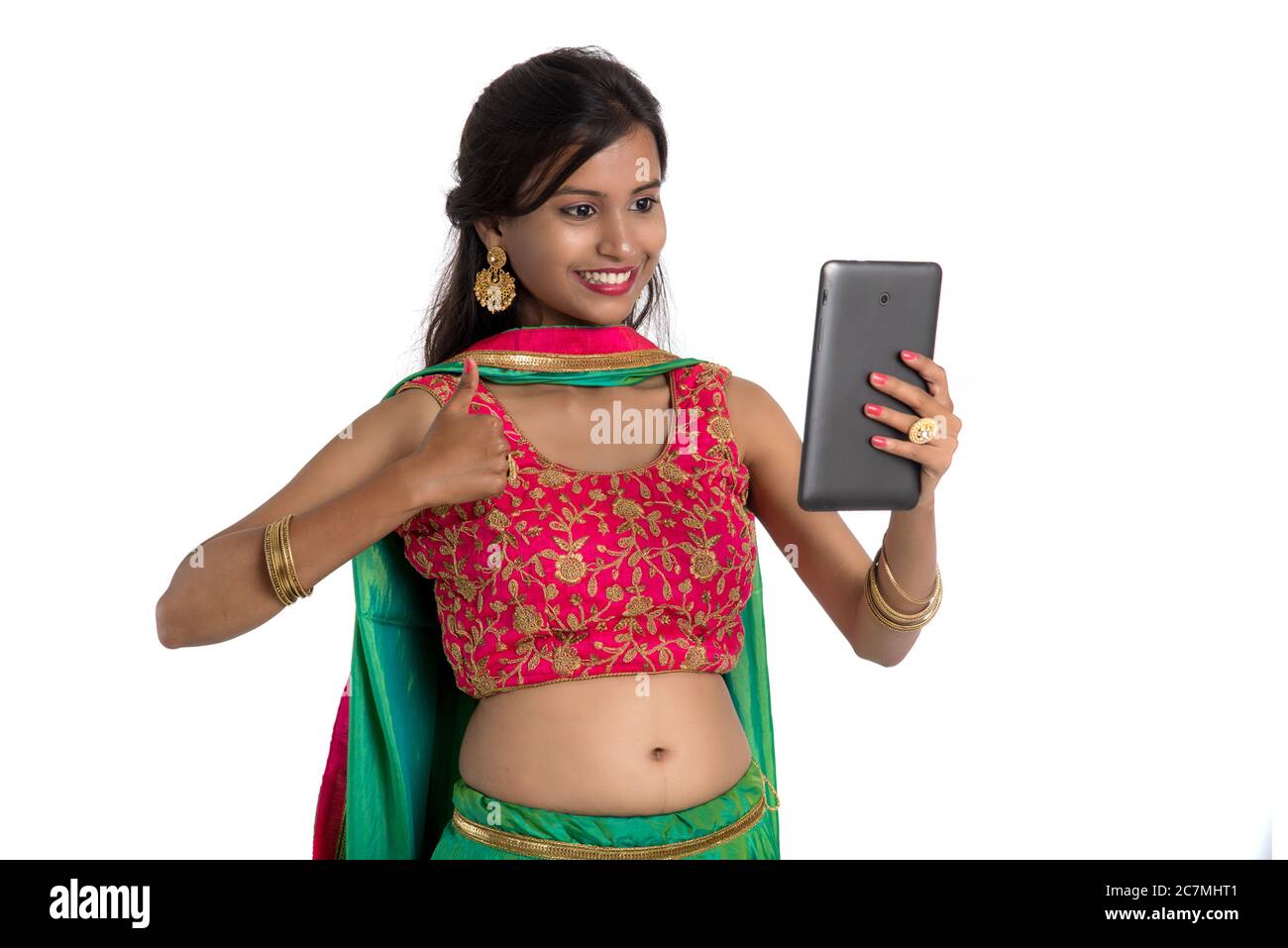 Young Indian traditional girl using a mobile phone or smartphone ...