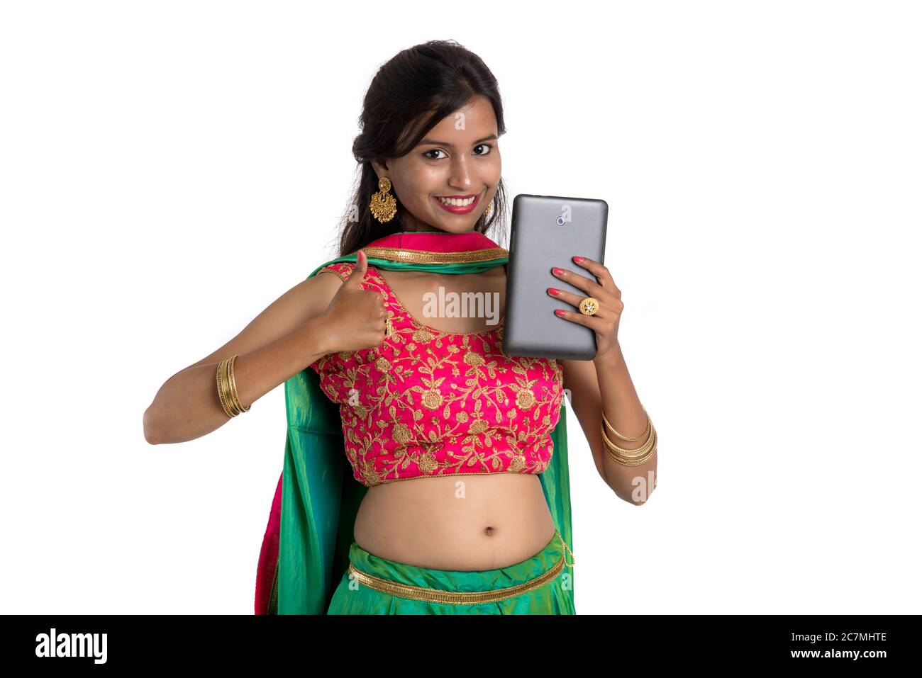 Young Indian traditional girl using a mobile phone or smartphone ...