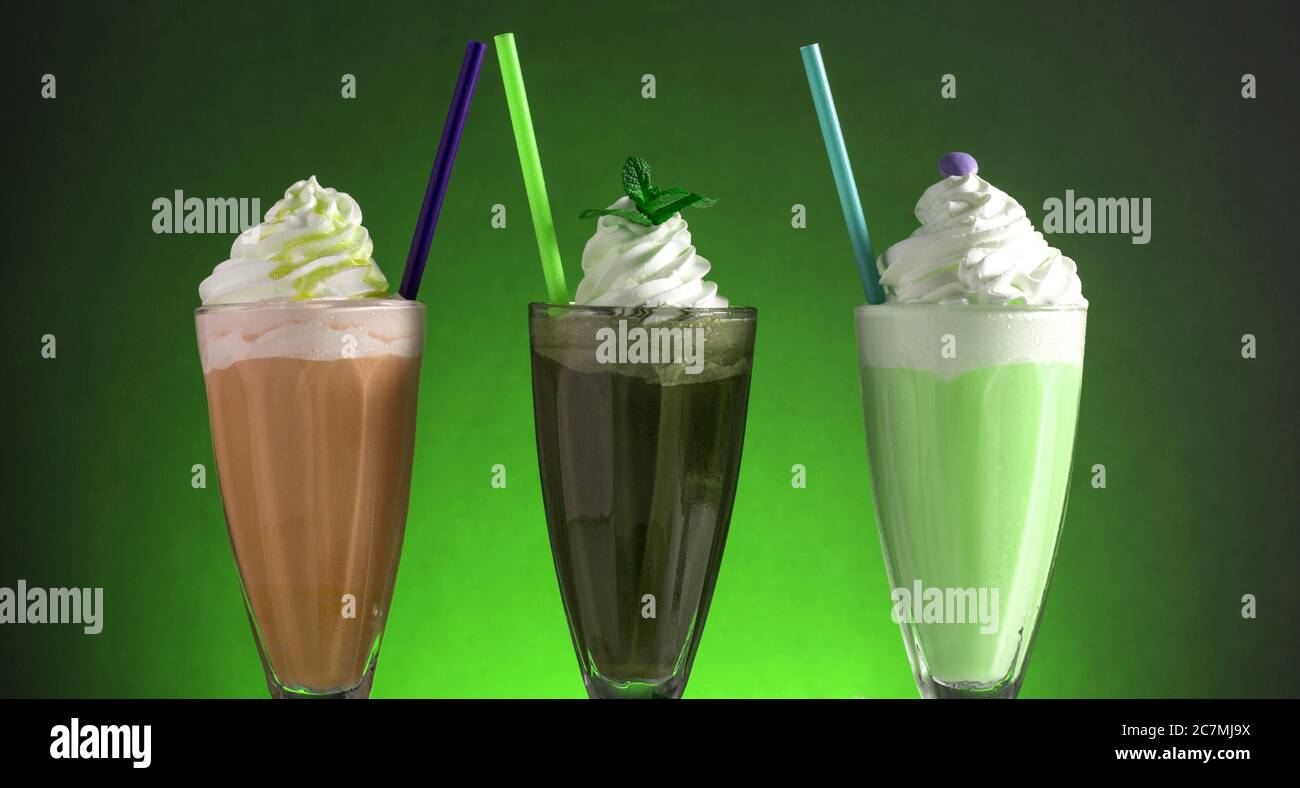 Milk shake with a cream topping and a straw Stock Photo - Alamy