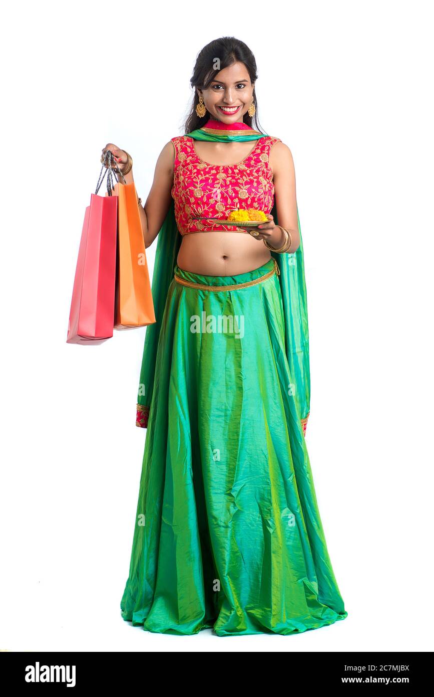 Beautiful Indian young girl holding and posing with shopping bags and ...