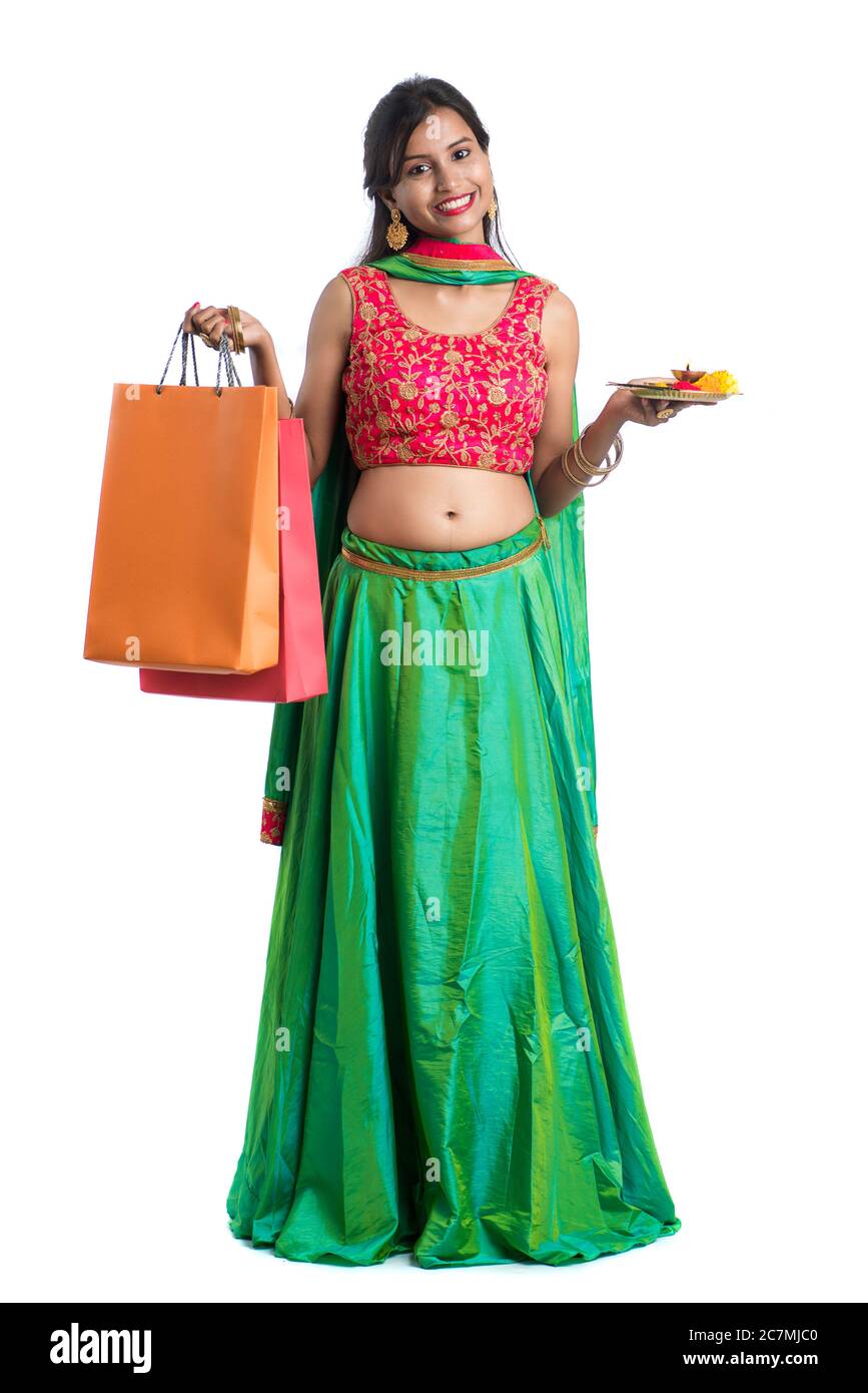 Beautiful Indian young girl holding and posing with shopping bags and ...
