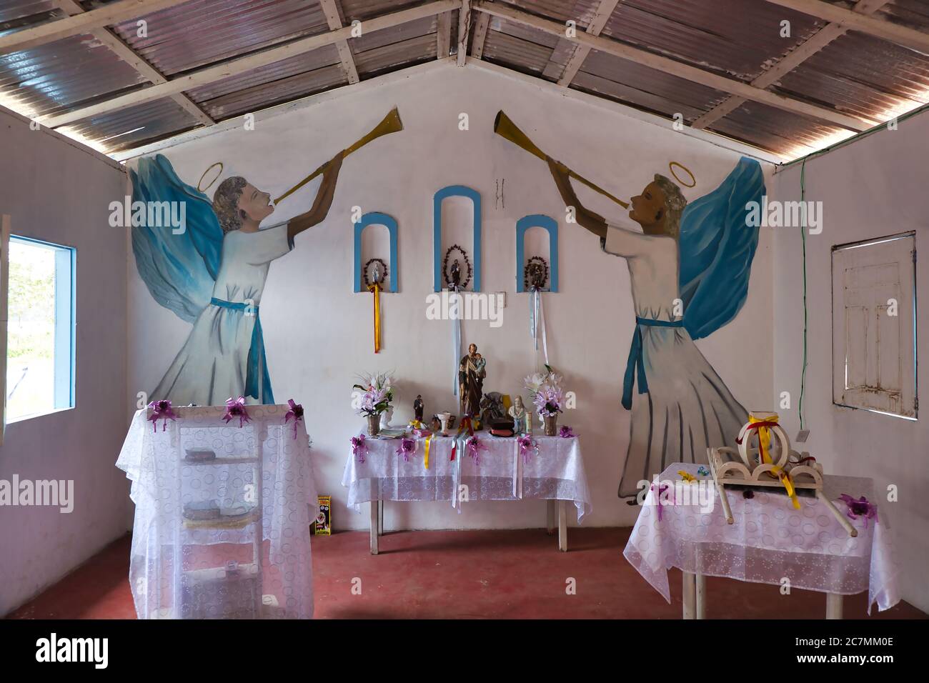 A pretty little village Church interior with a painting on the wall of ...
