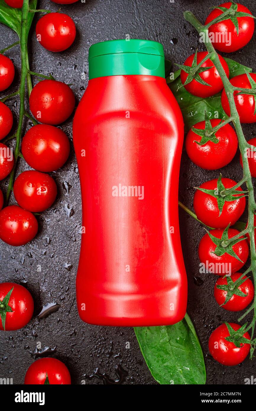 a bottle, a tube of red ketchup with a green cap and two ripe branches ...