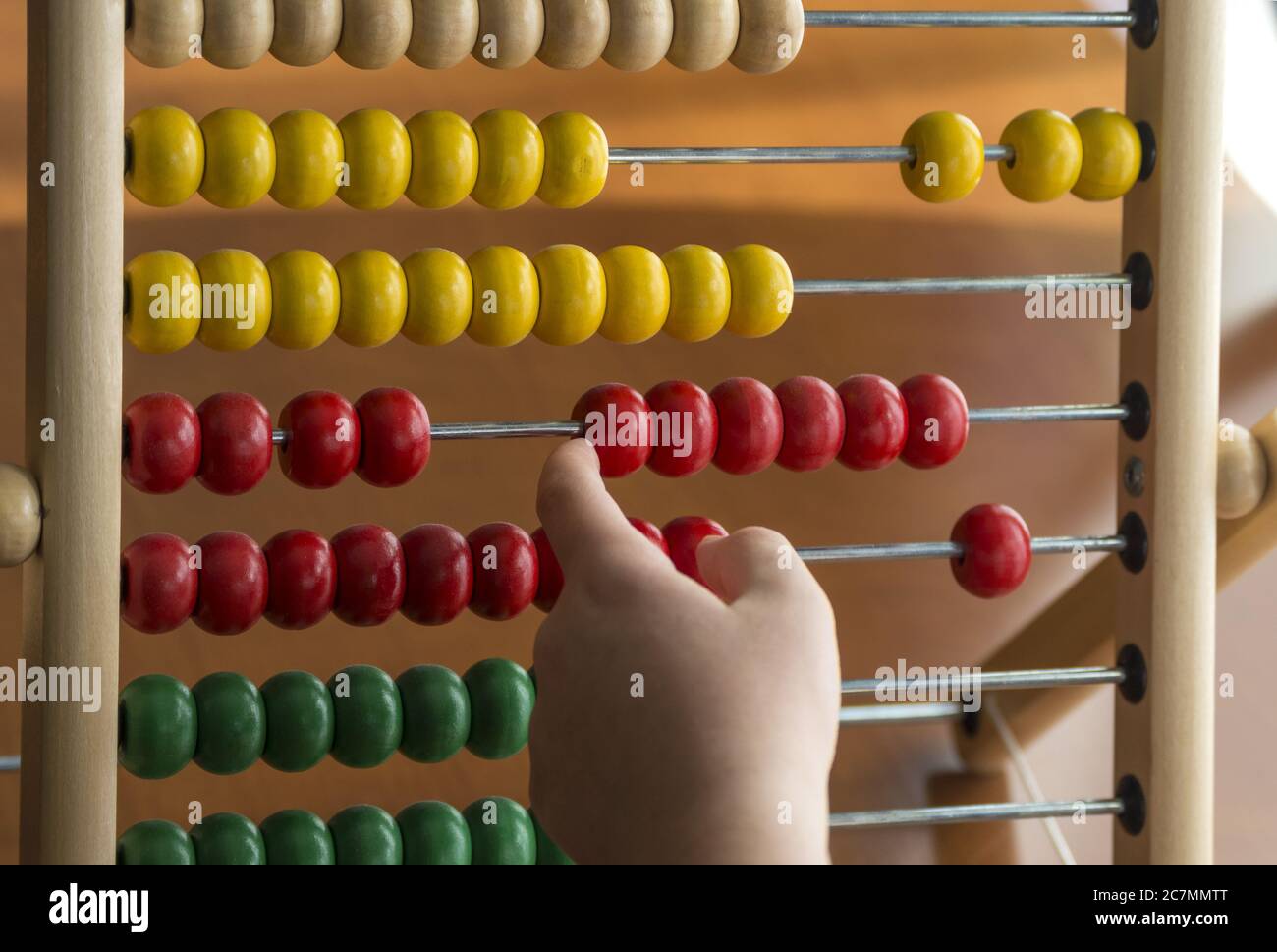 Closeup shot of a child hand used a wooden abacus at home Stock Photo ...