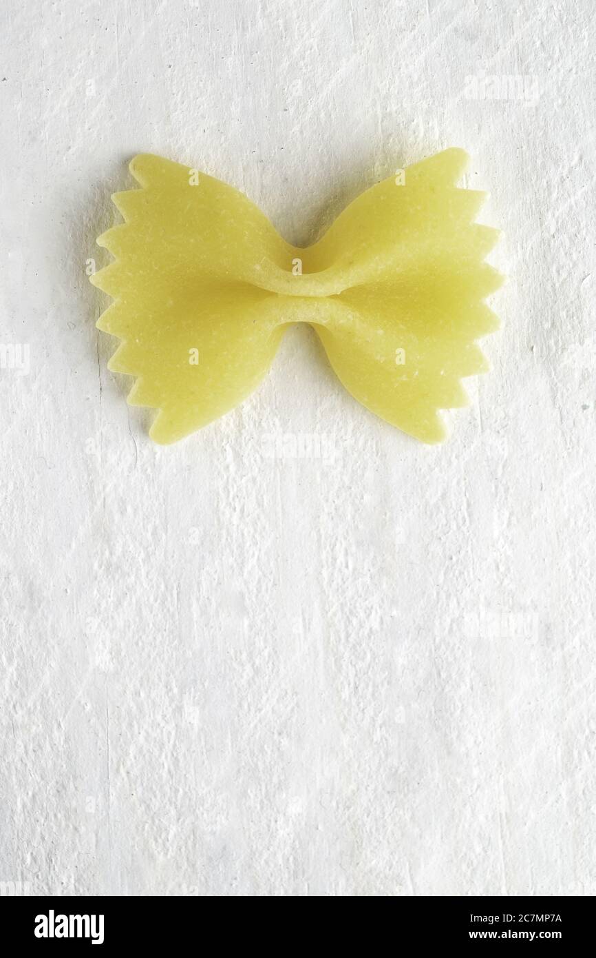 Shot of a single bow tie pasta isolated in a white background Stock ...